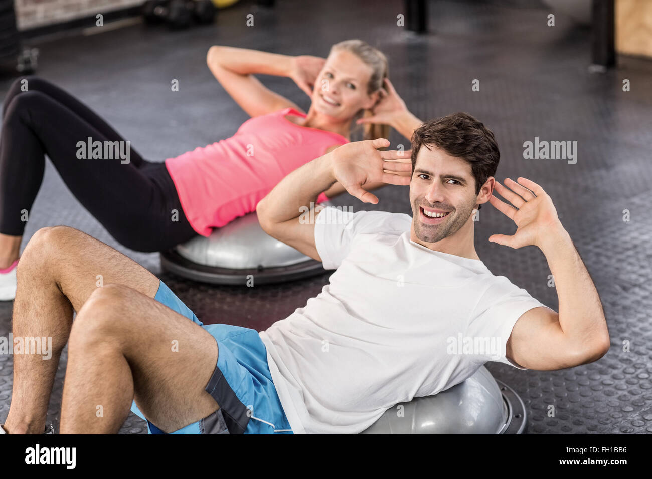 Fit couple doing abdominal crunches Stock Photo - Alamy