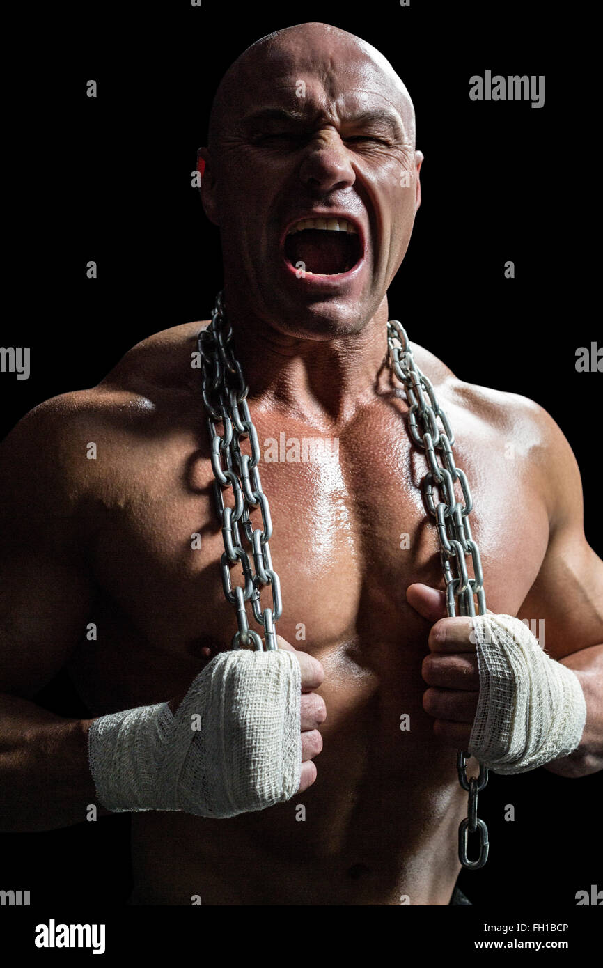 Aggressive fighter holding chain Stock Photo - Alamy