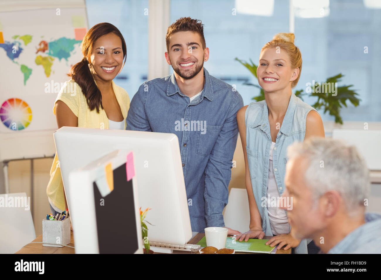 Portrait of smiling business people using computer Stock Photo - Alamy