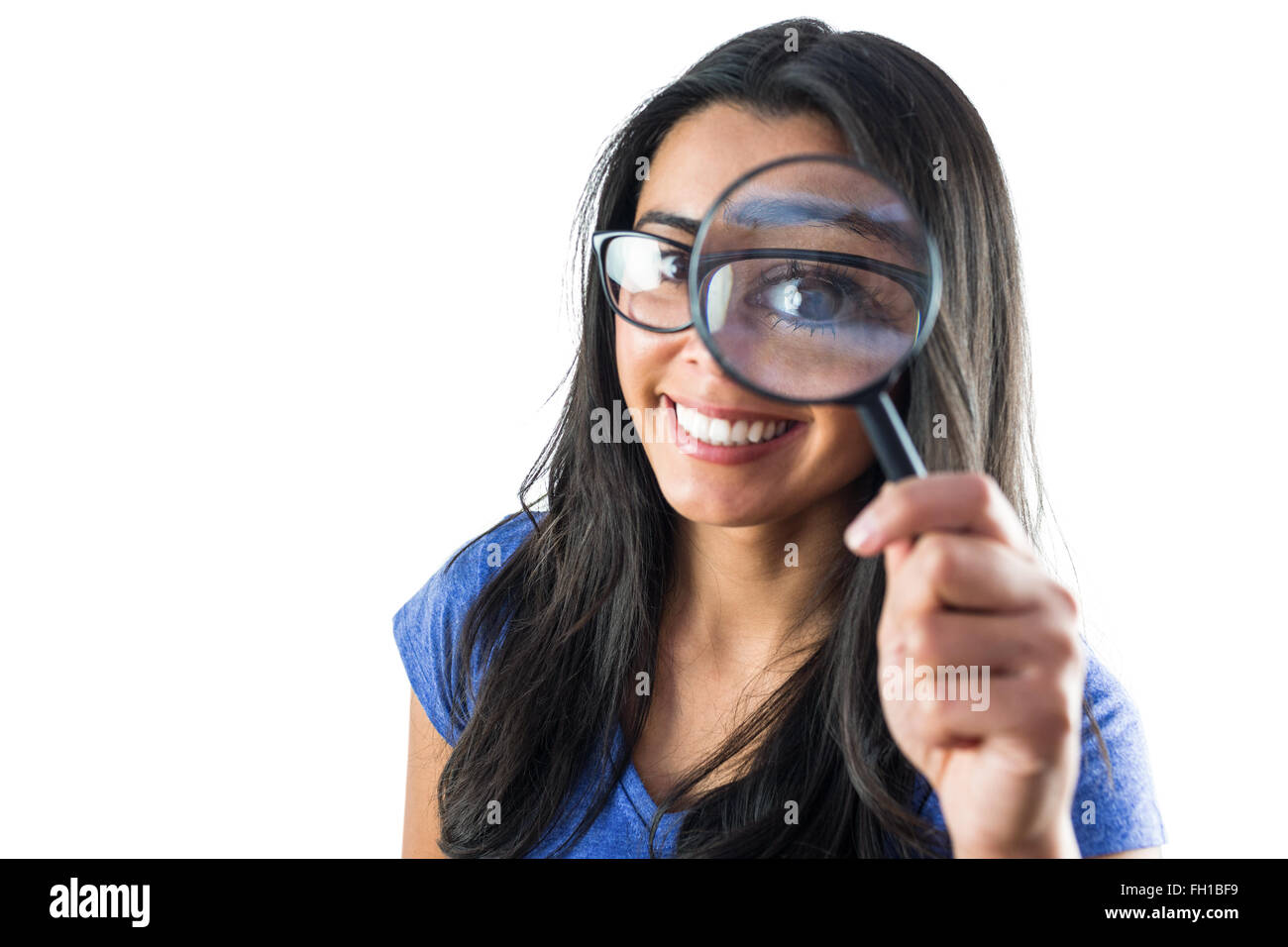 Happy woman using a magnifying glass Stock Photo - Alamy