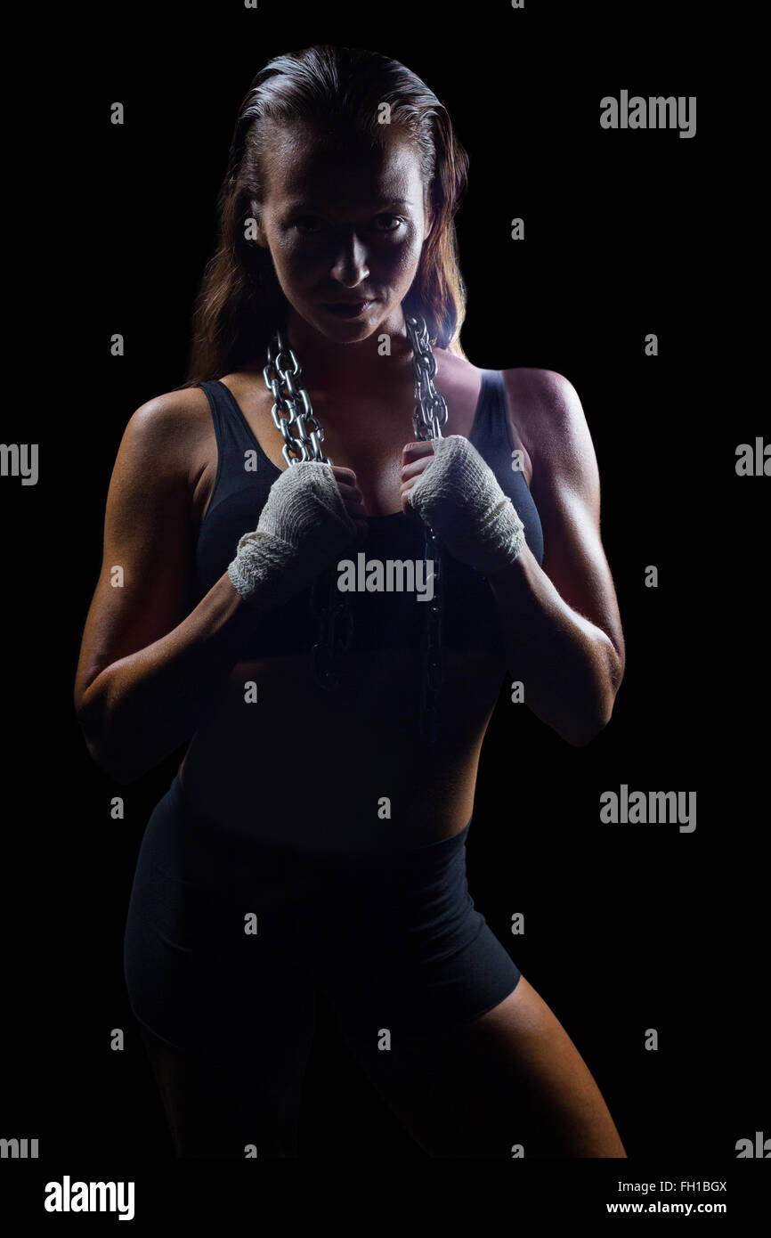 Portrait of female fighter holding chain around neck Stock Photo - Alamy