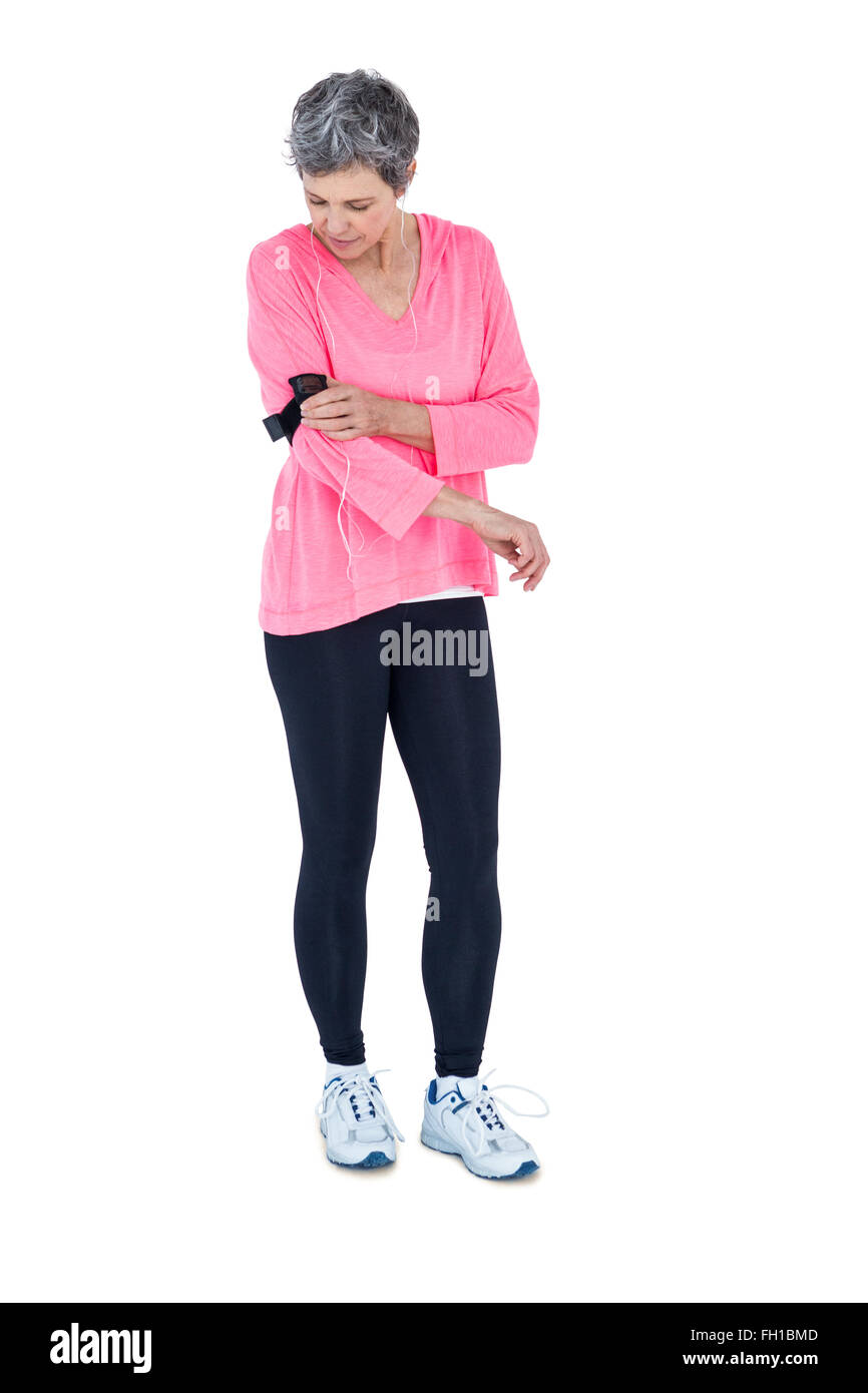 Full length of fit woman wearing armband Stock Photo - Alamy