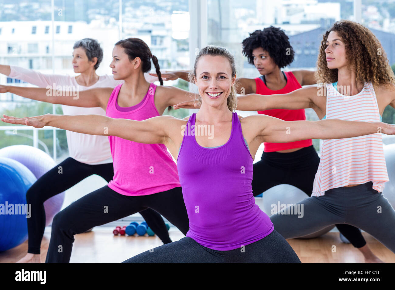 Group of women exercising with arms outstretched Stock Photo - Alamy