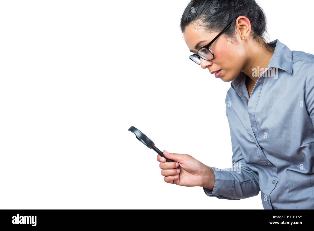Woman examining with a magnifying glass Stock Photo - Alamy
