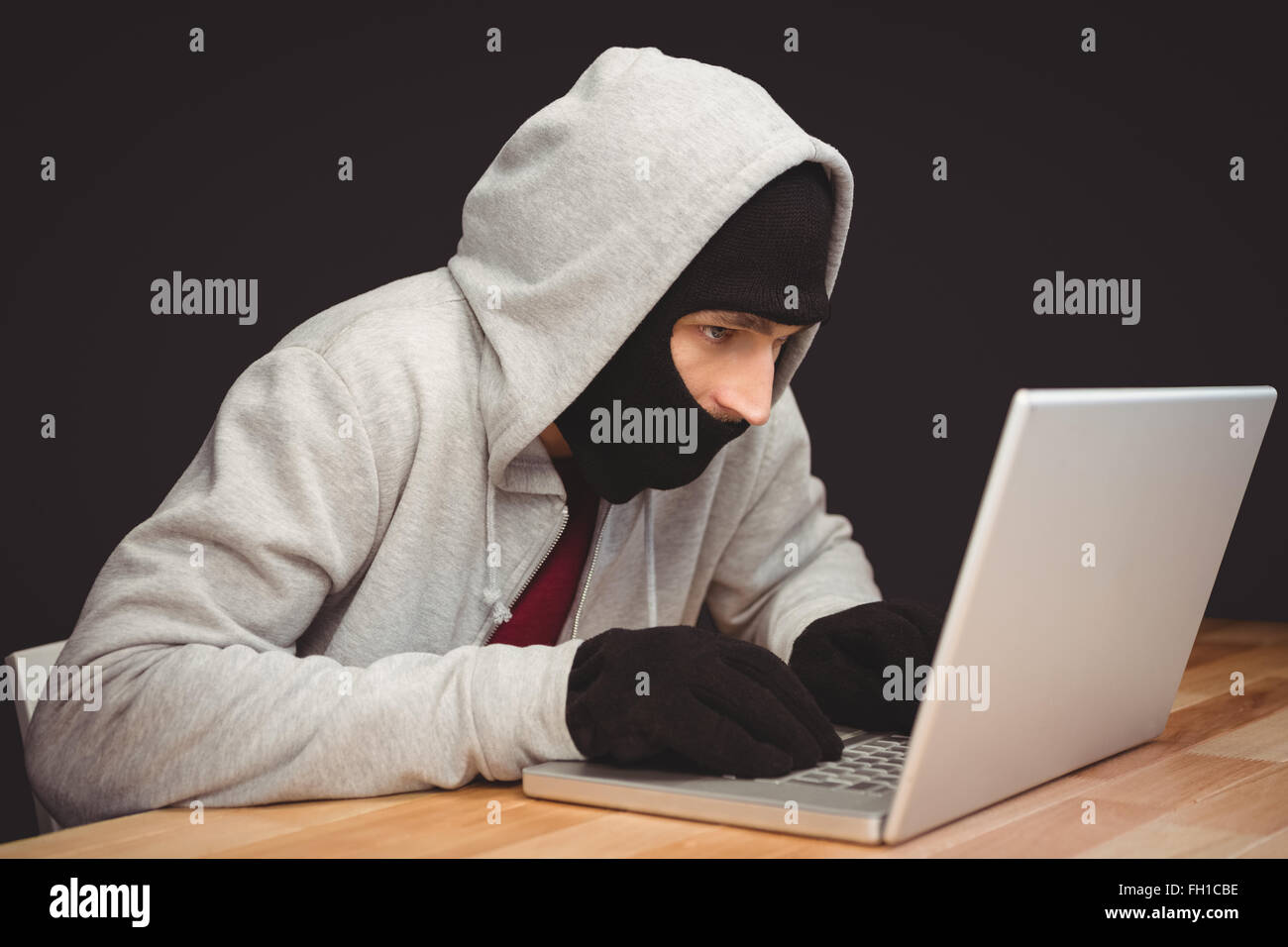 Hacker using laptop Stock Photo - Alamy