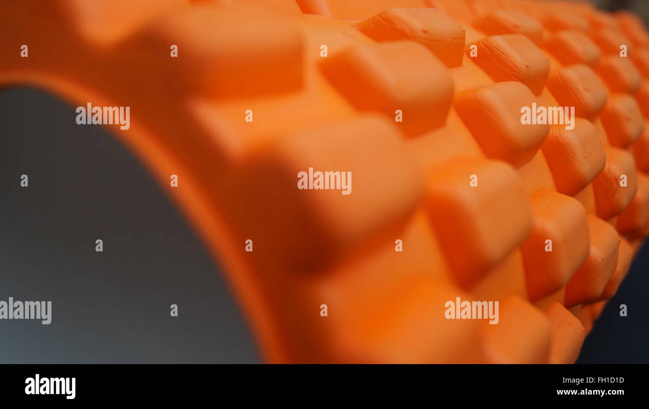 Orange exercise foam roller Stock Photo - Alamy