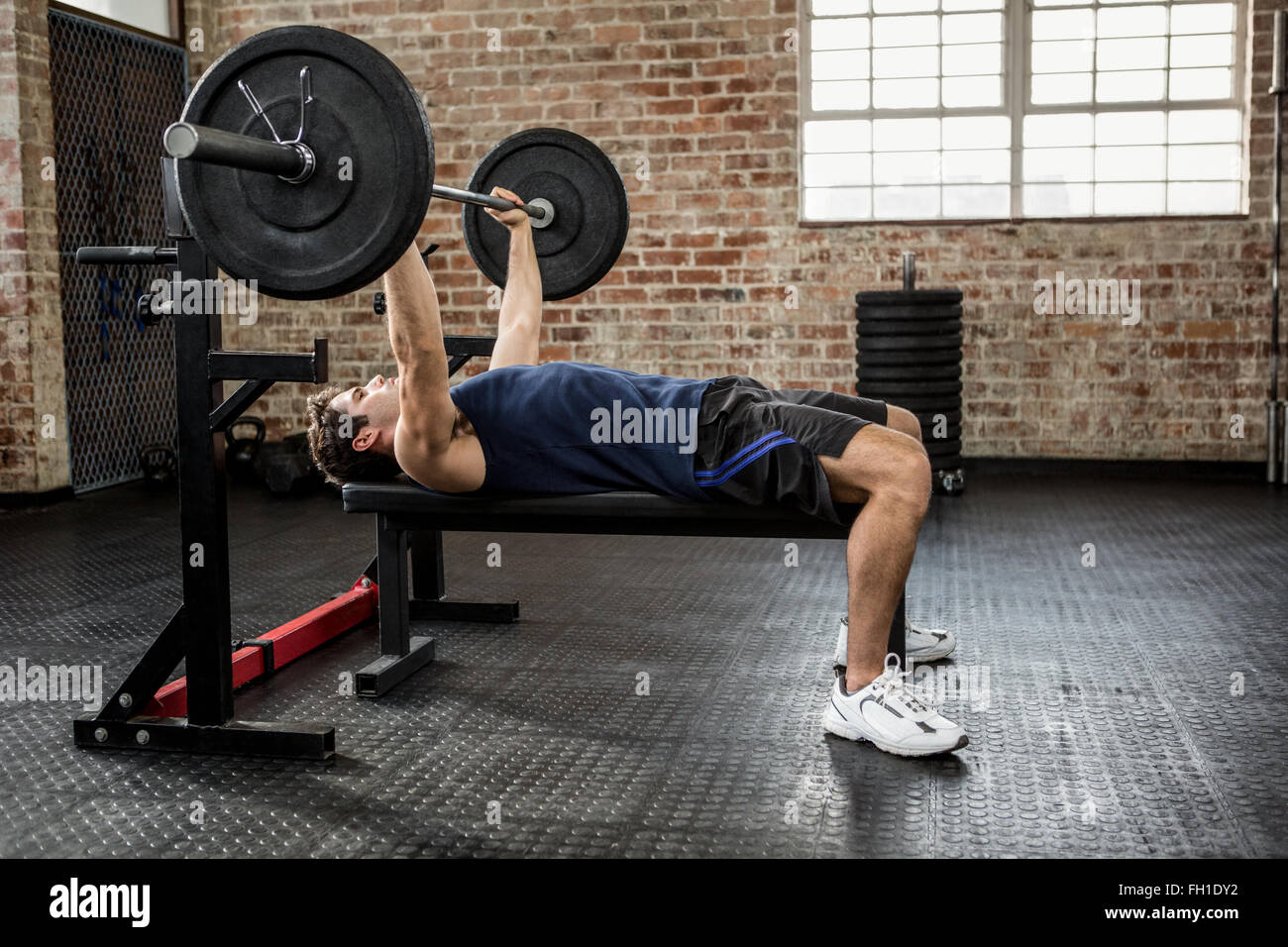 Side view of a man lifting barbell Stock Photo - Alamy
