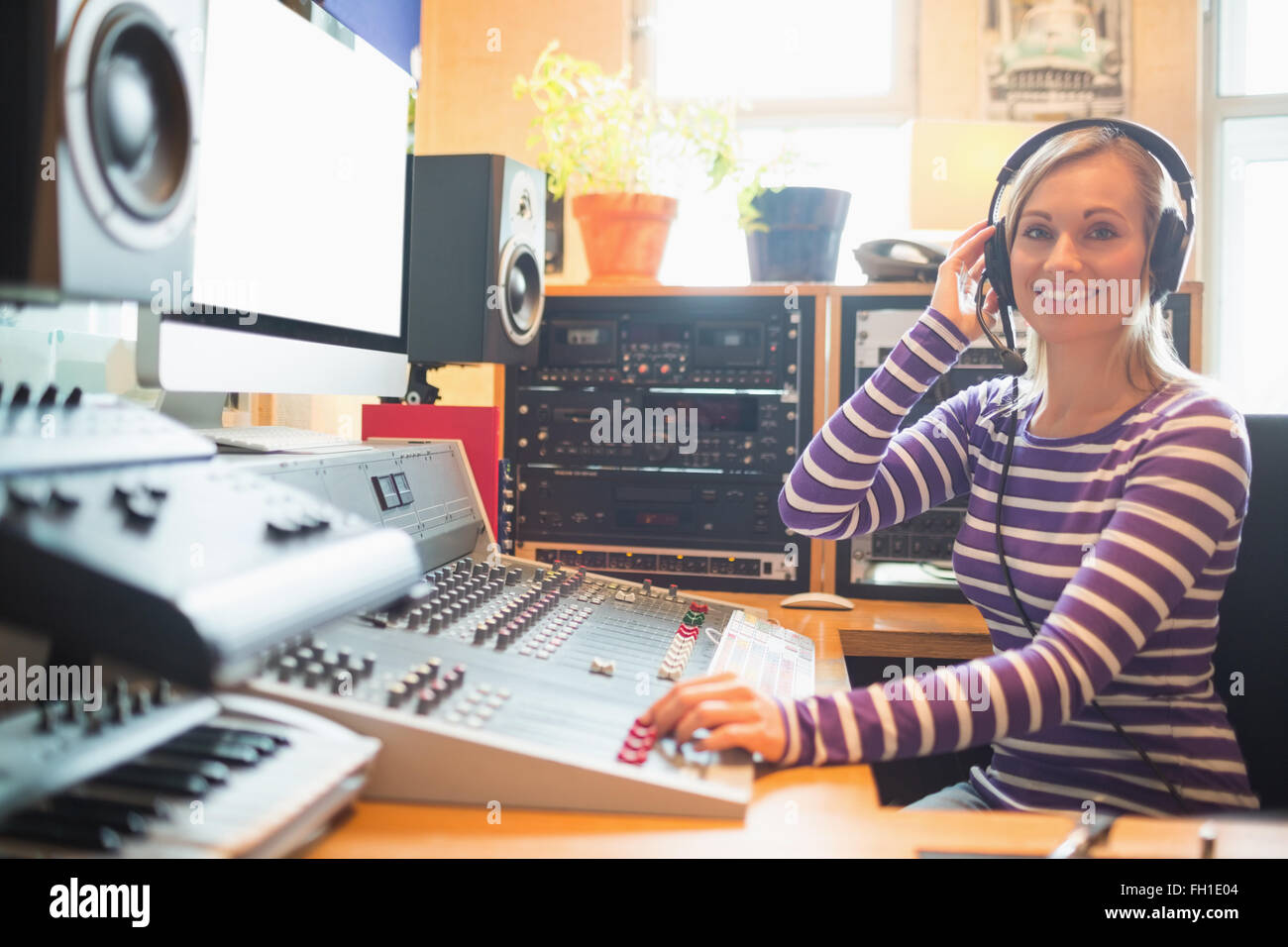 Radio host using sound mixer Stock Photo - Alamy