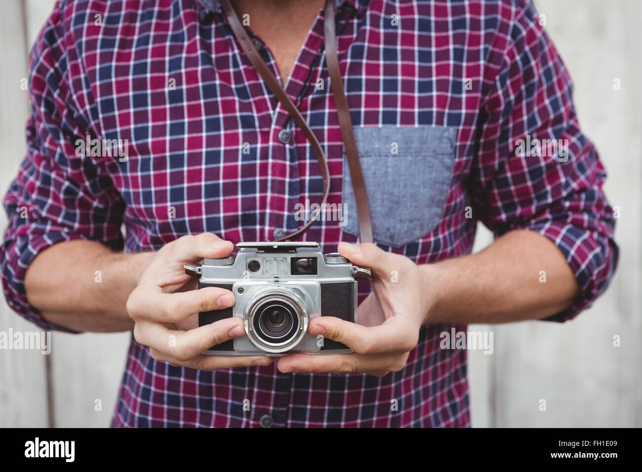 Mid section of man using camera Stock Photo - Alamy
