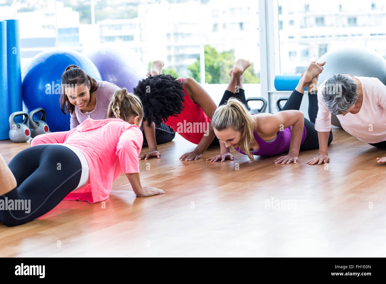 Women exercising on floor with trainer Stock Photo - Alamy