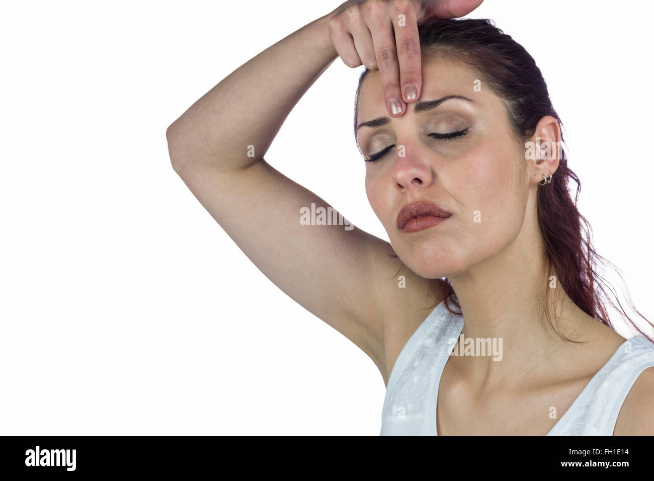 Beautiful woman with eyes closed white touching forehead Stock Photo ...