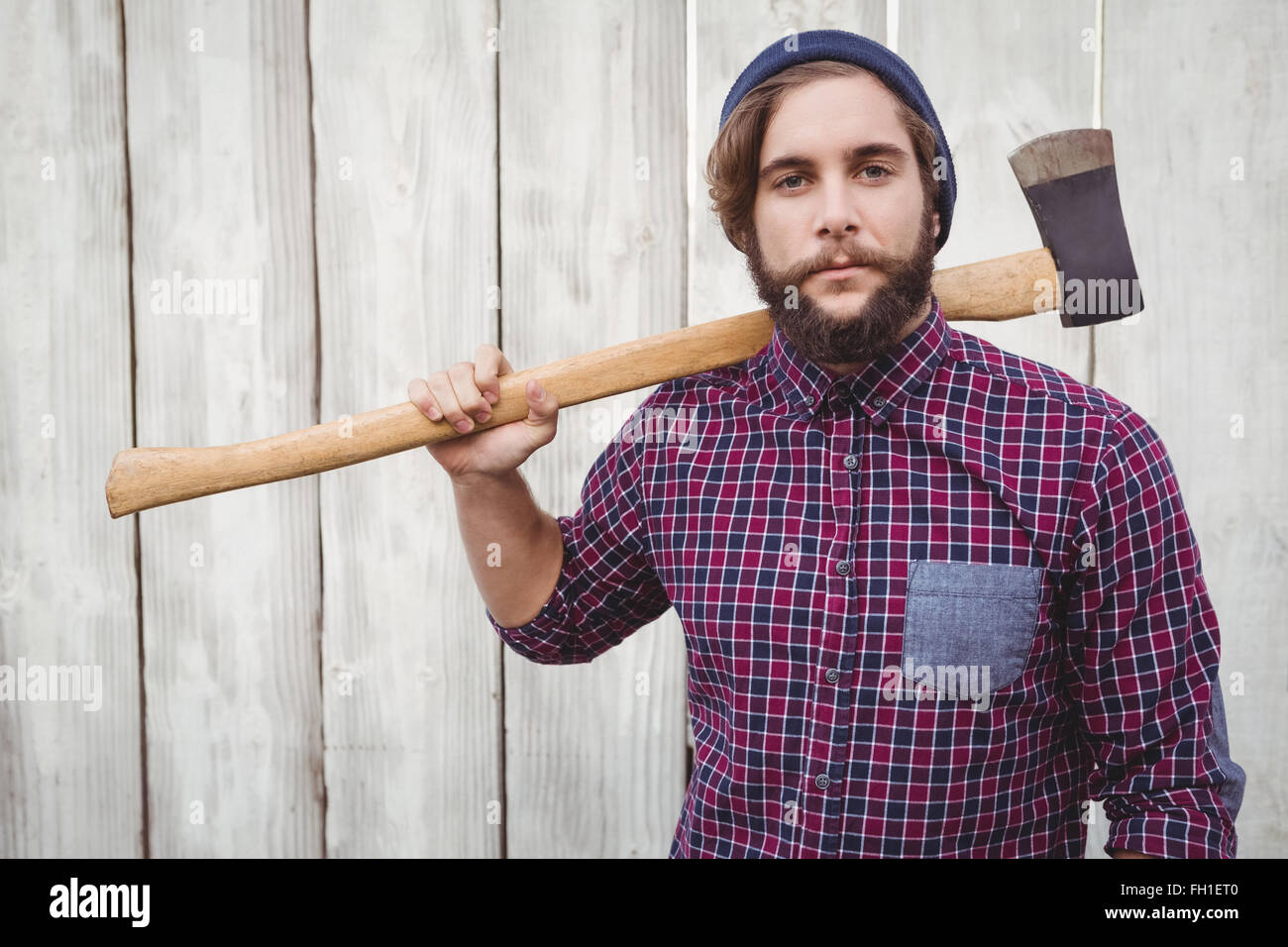 Hipster holding axe on shoulder Stock Photo - Alamy