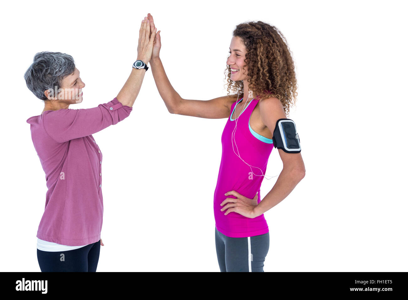 Cheerful female friends high fiving Stock Photo - Alamy