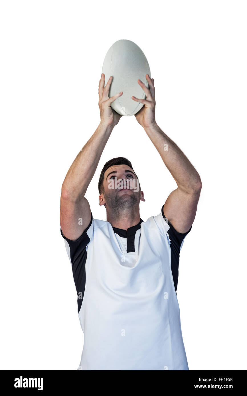 Rugby player holding rugby ball Stock Photo - Alamy