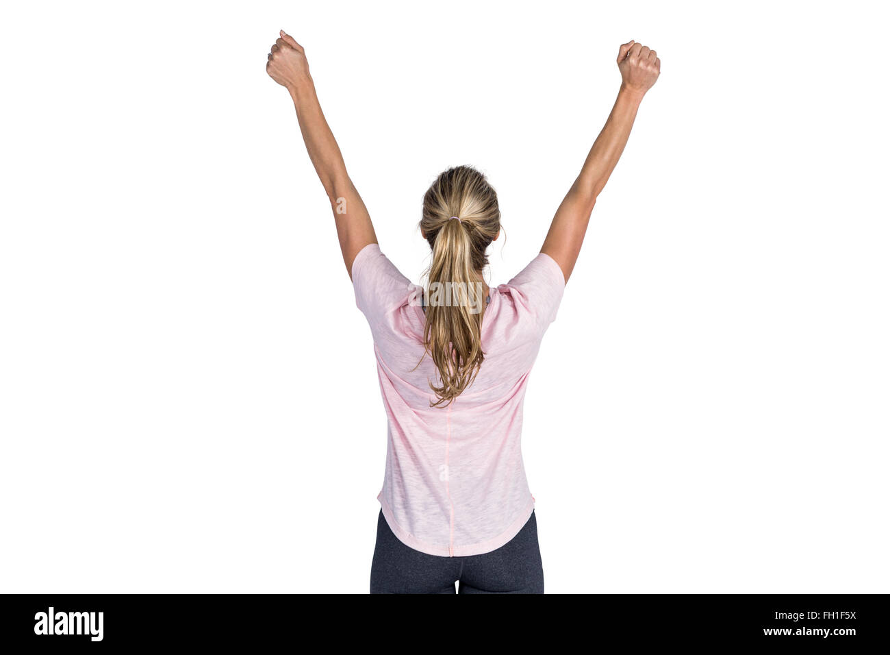 Rear view of woman cheering with arms raised Stock Photo - Alamy