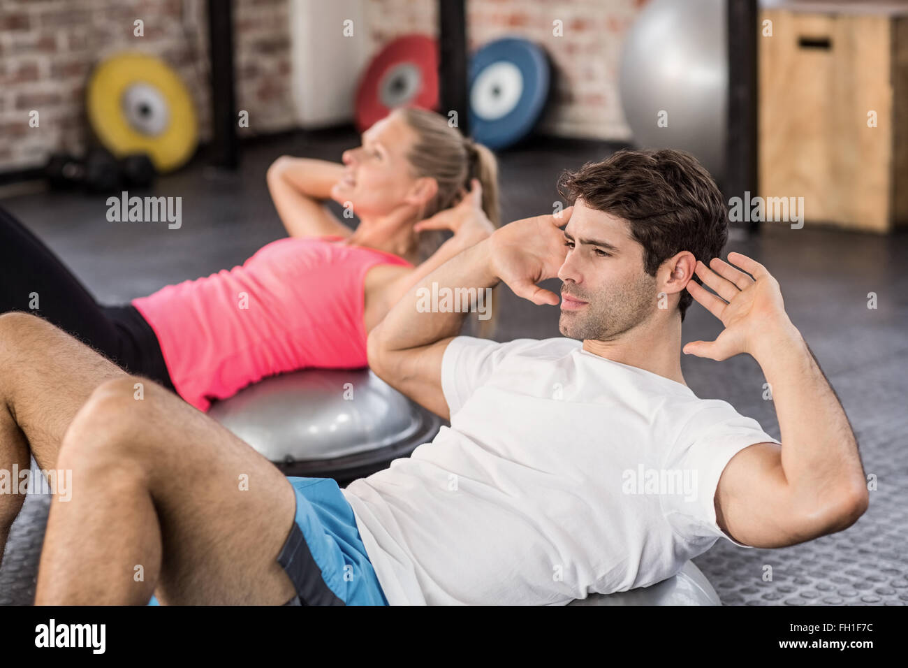 Fit couple doing abdominal crunches Stock Photo - Alamy