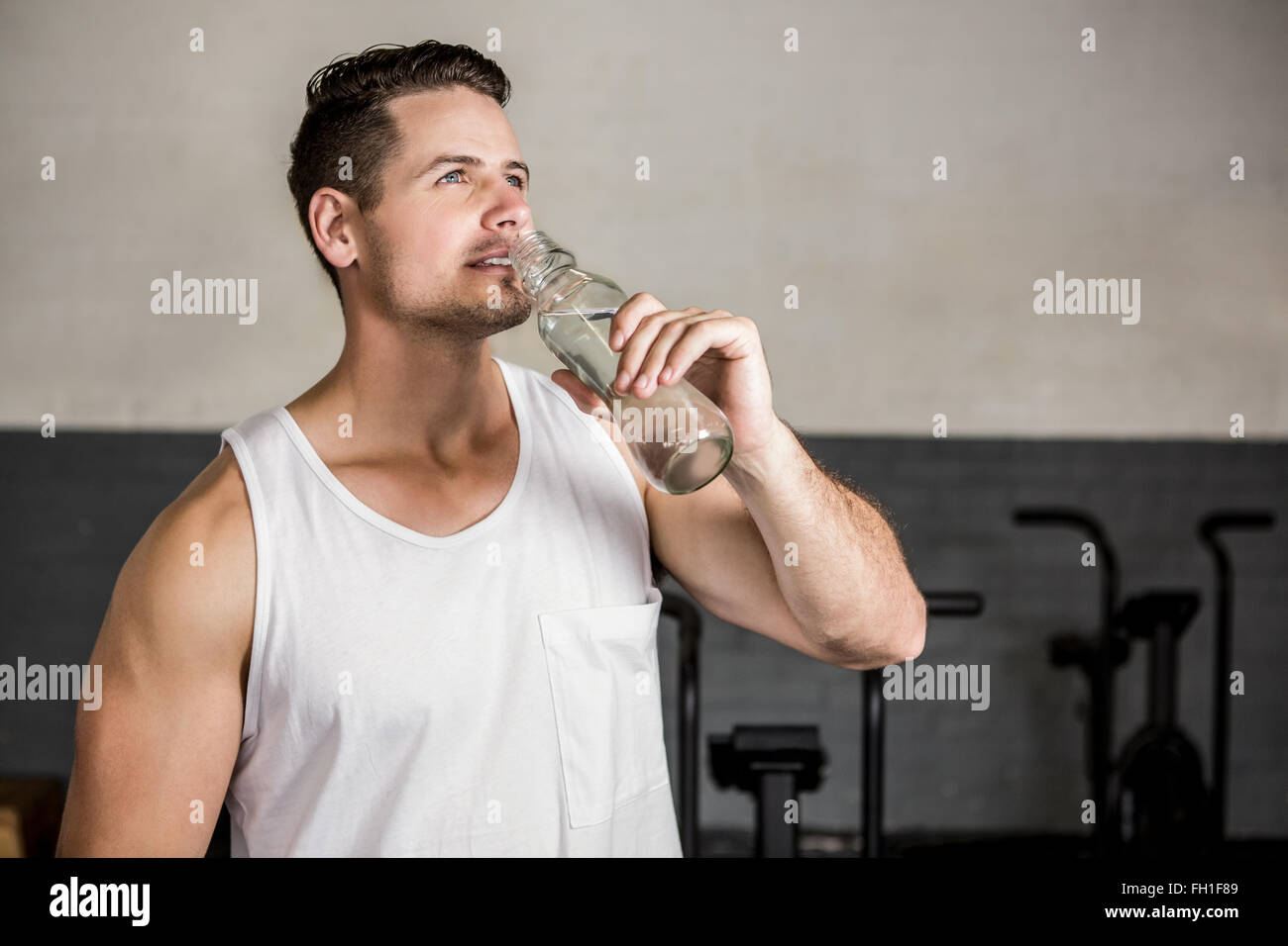 Muscular man holding bottle Stock Photo - Alamy