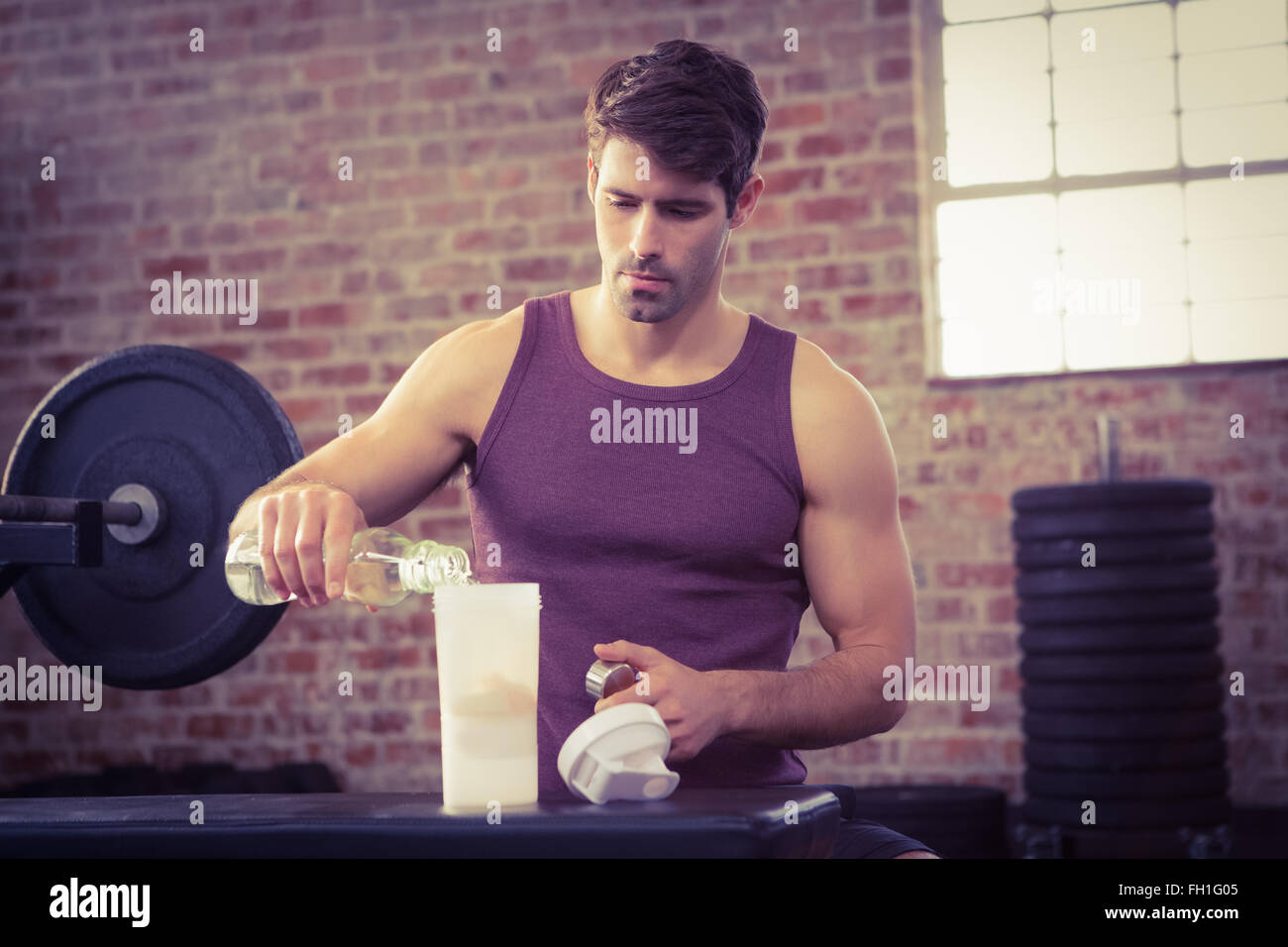 Man pouring water into shaker bottle Stock Photo - Alamy