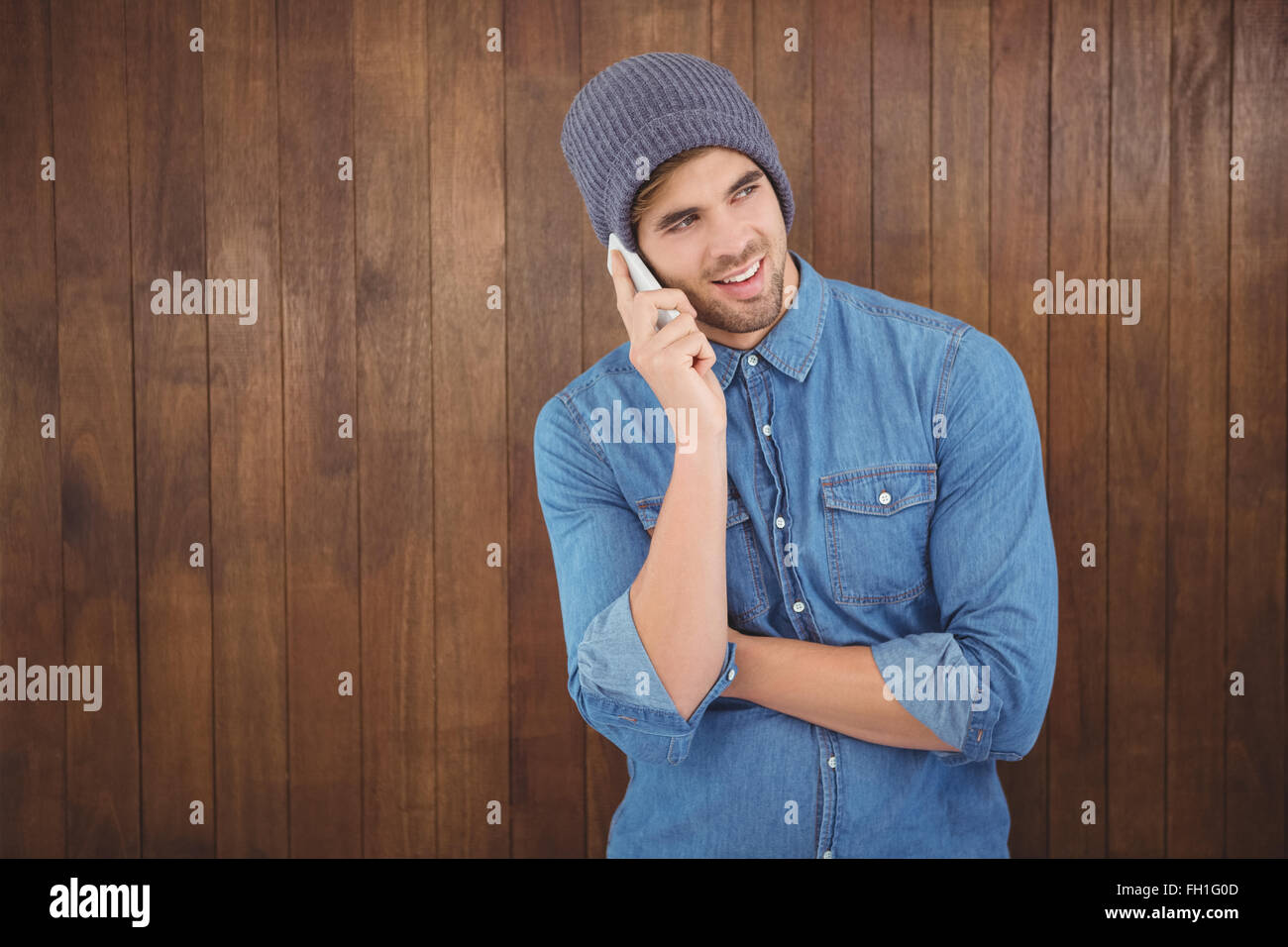 Hipster wearing klnitted hat using mobile phone Stock Photo - Alamy