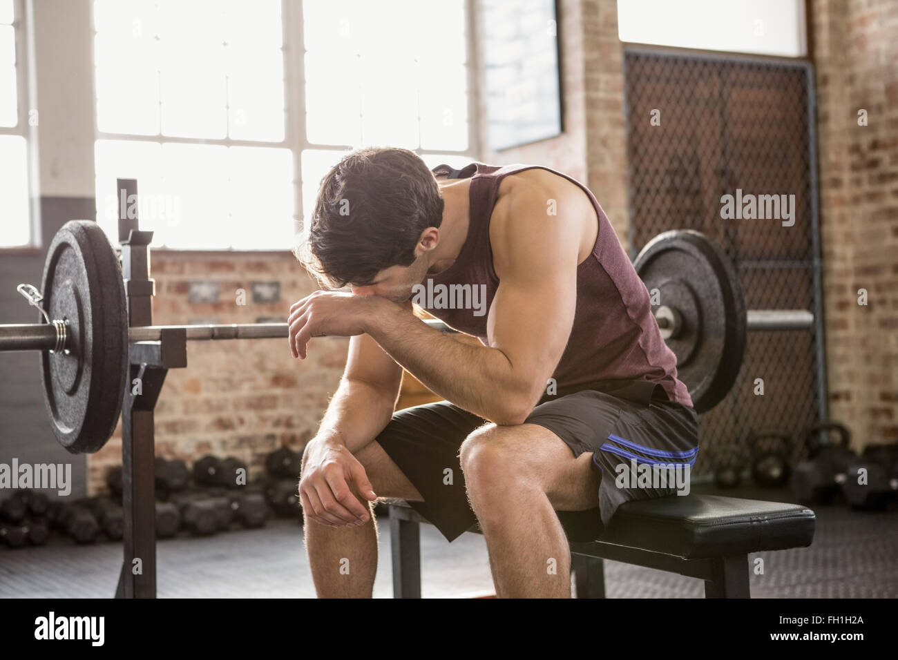 Tired man sitting on the bench Stock Photo - Alamy