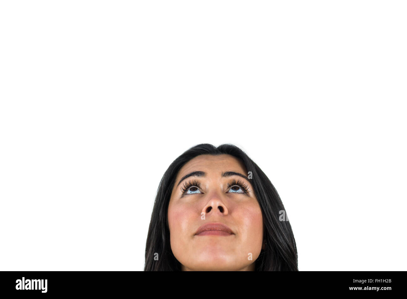 Cute woman looking above her Stock Photo - Alamy