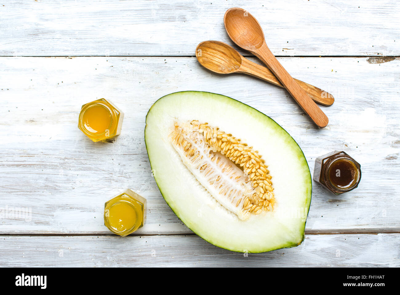 melon spoon and honey on white board board in rustic style Stock Photo ...