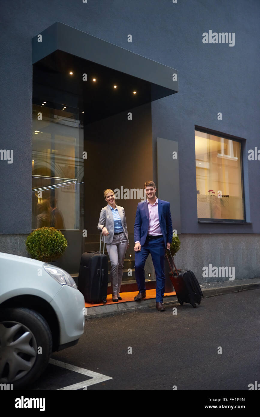 business people couple entering hotel Stock Photo - Alamy