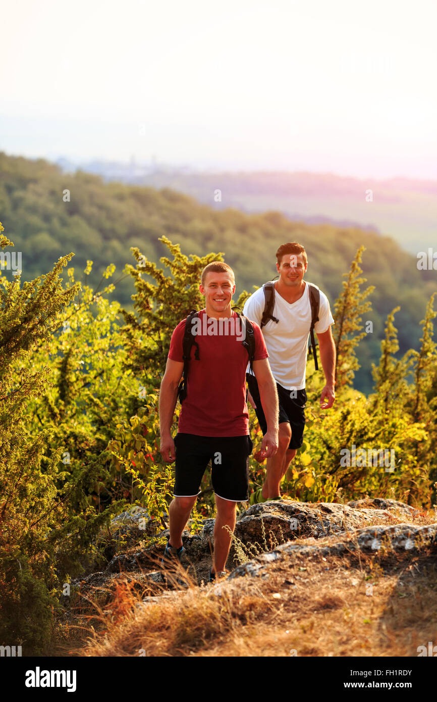 Two men hiking on the top of mountain Stock Photo - Alamy