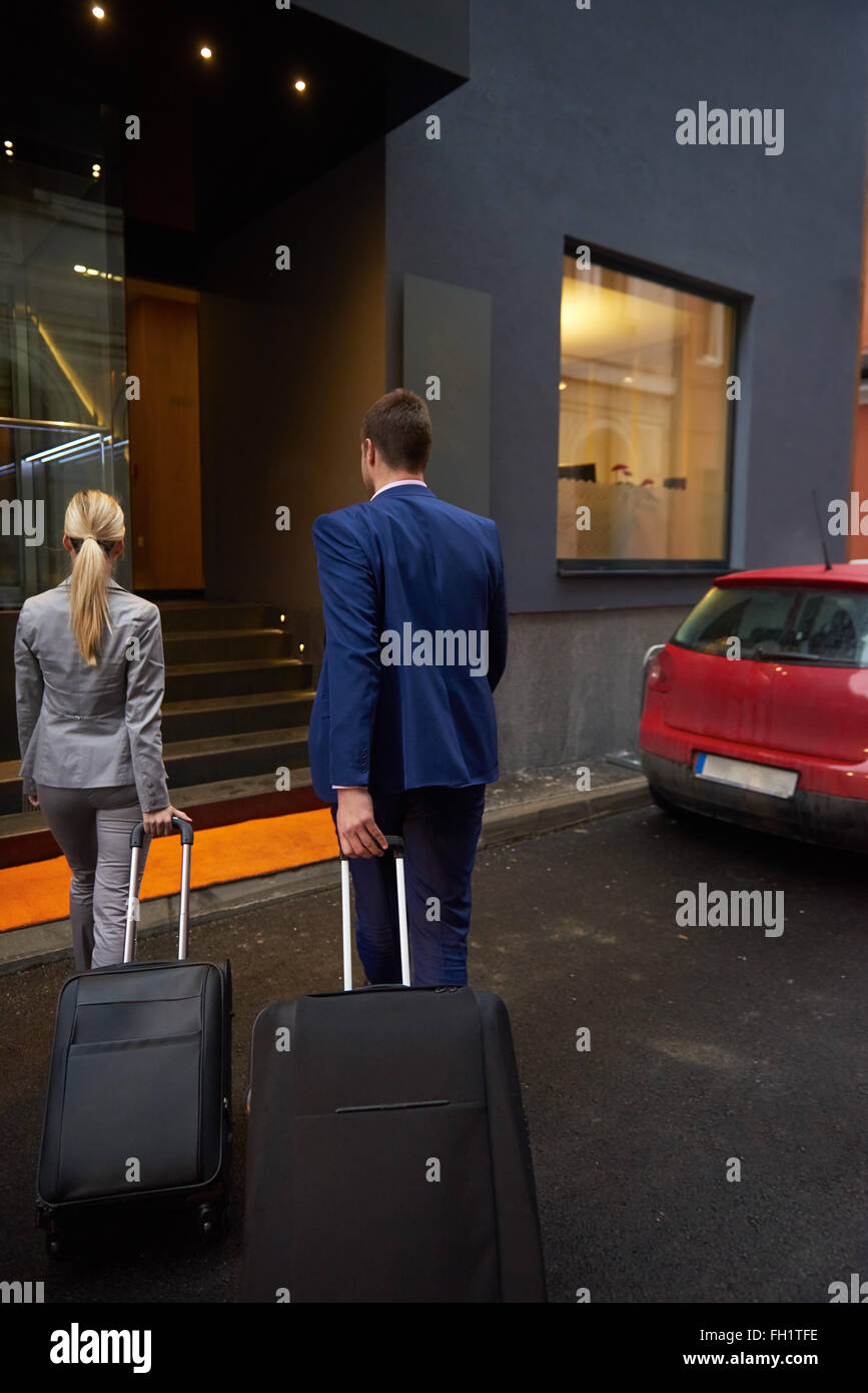 business people couple entering hotel Stock Photo - Alamy