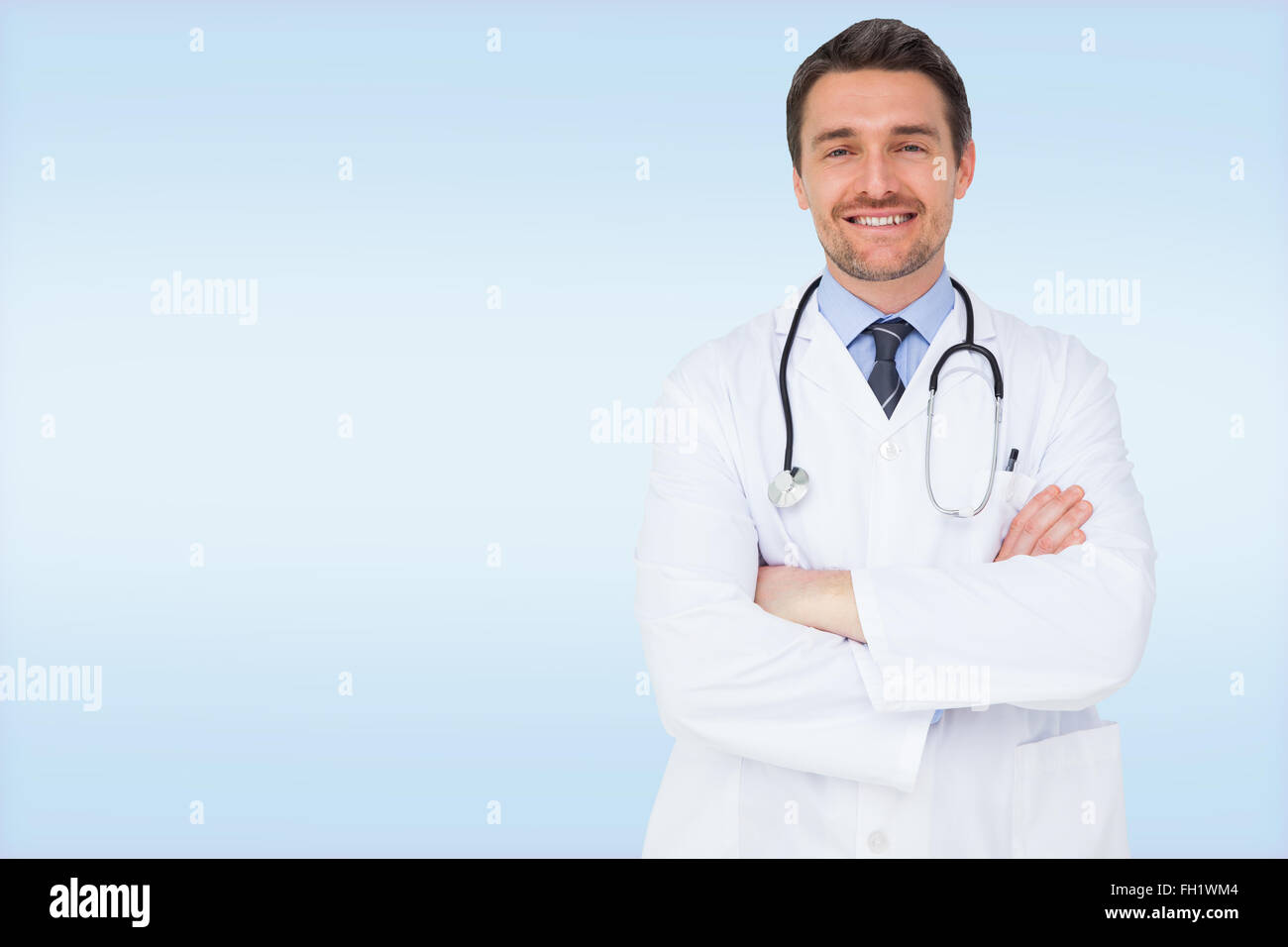Composite image of handsome young doctor with arms crossed Stock Photo ...