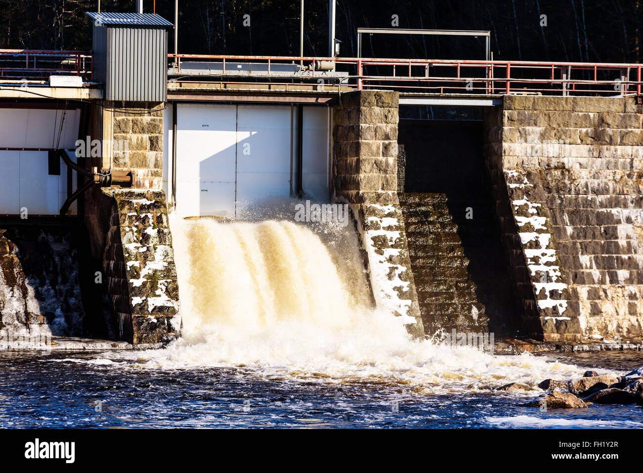 A small waterfall through a partly open water gate. The river Morrumsan ...