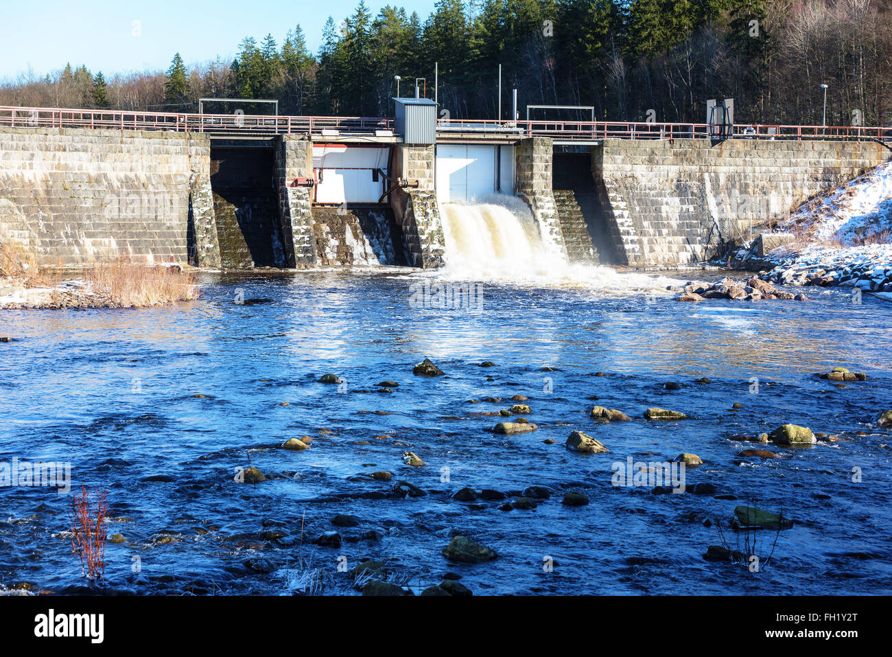 A small waterfall through a partly open water gate. The river Morrumsan ...