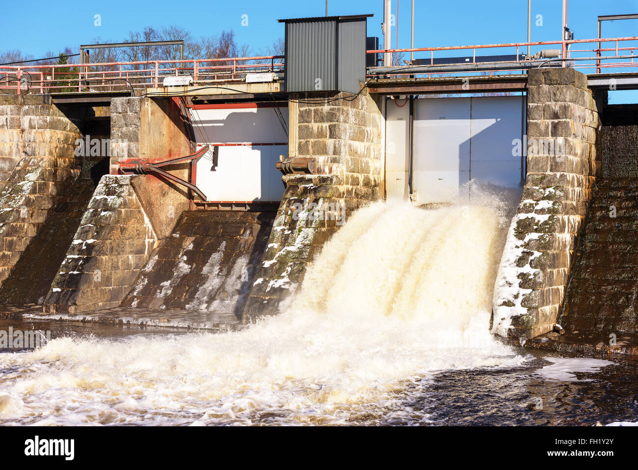 A small waterfall through a partly open water gate. The river Morrumsan ...