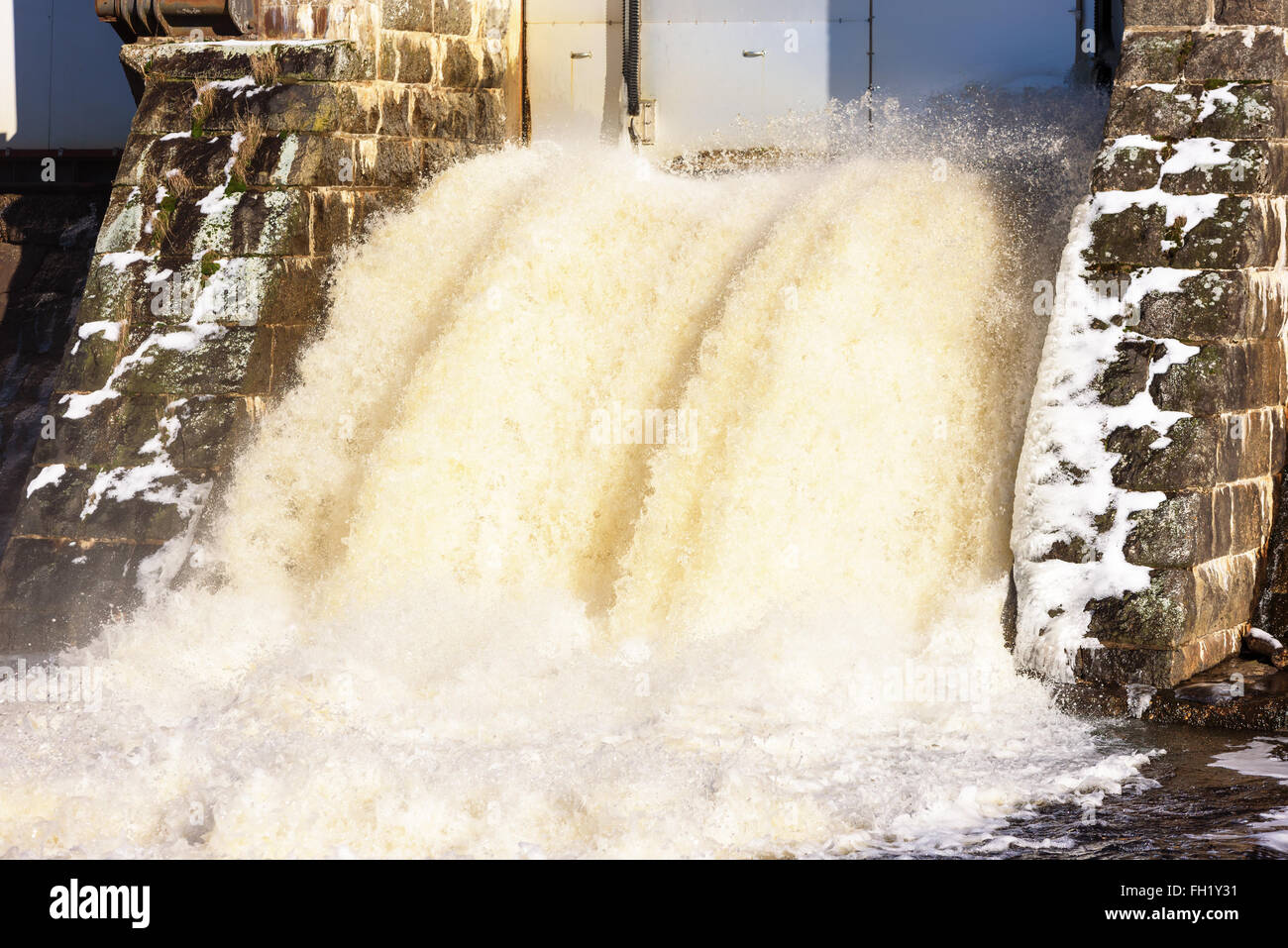 A small waterfall through a partly open water gate. The river Morrumsan ...