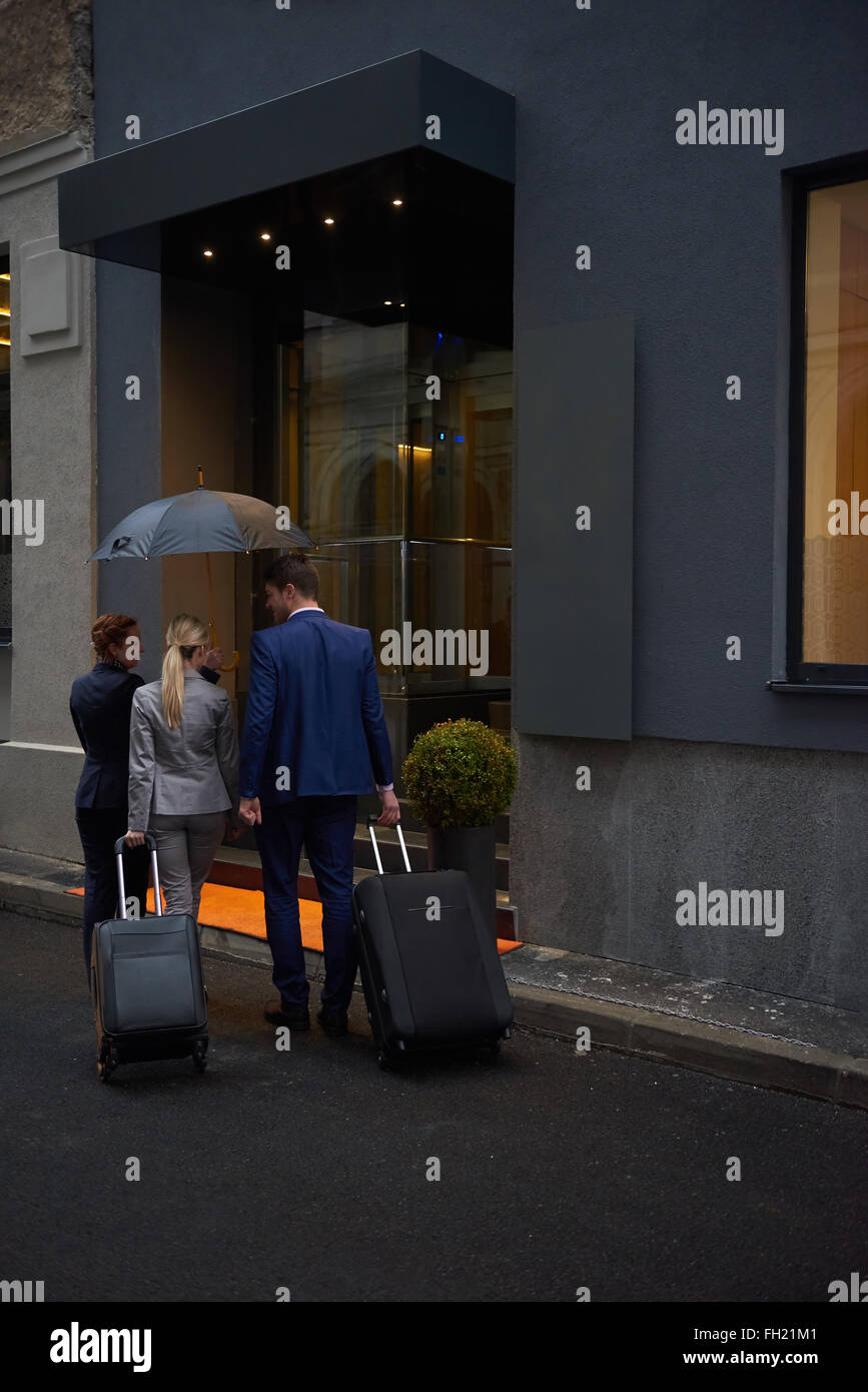 business people couple entering hotel Stock Photo - Alamy