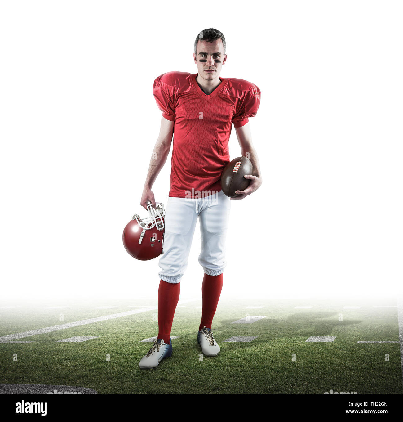 Composite image of a serious american football player taking his helmet ...