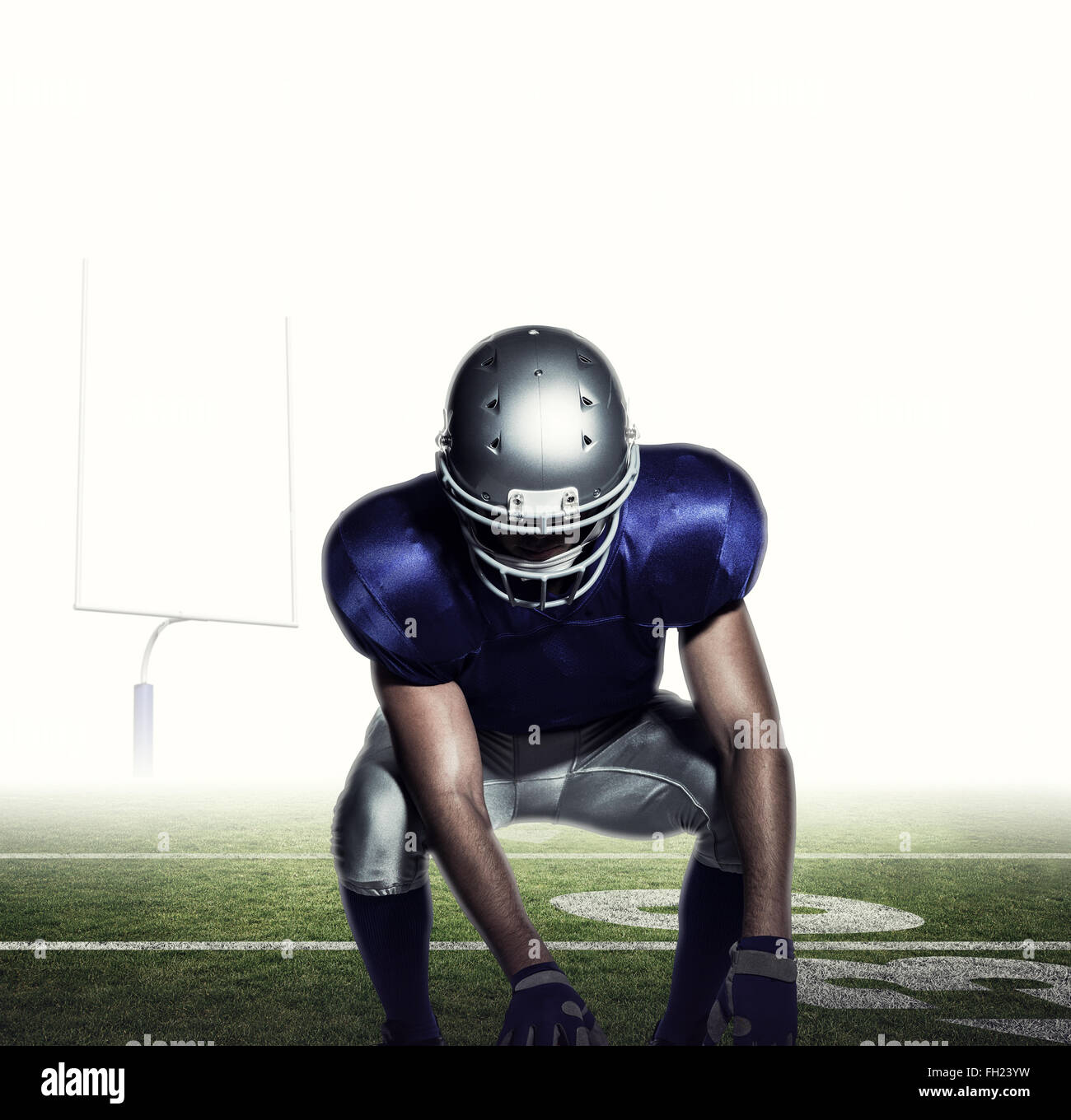 Composite image of american football player holding ball while ...