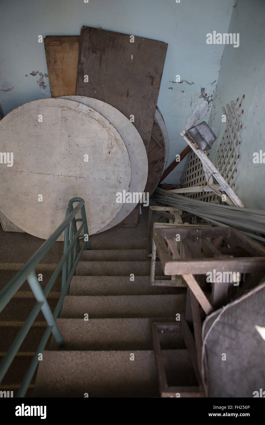 Old furniture and clutter causing an obstruction to the fire exit of a ...