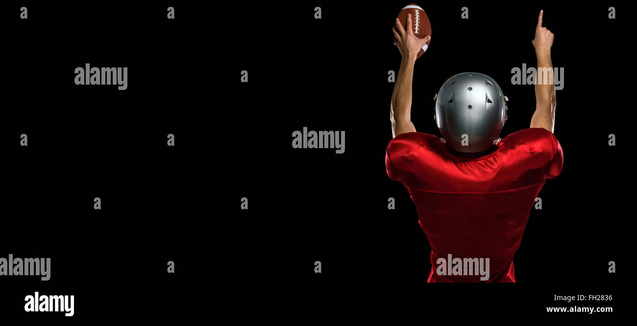 Composite image of rear view of american football player with arms ...