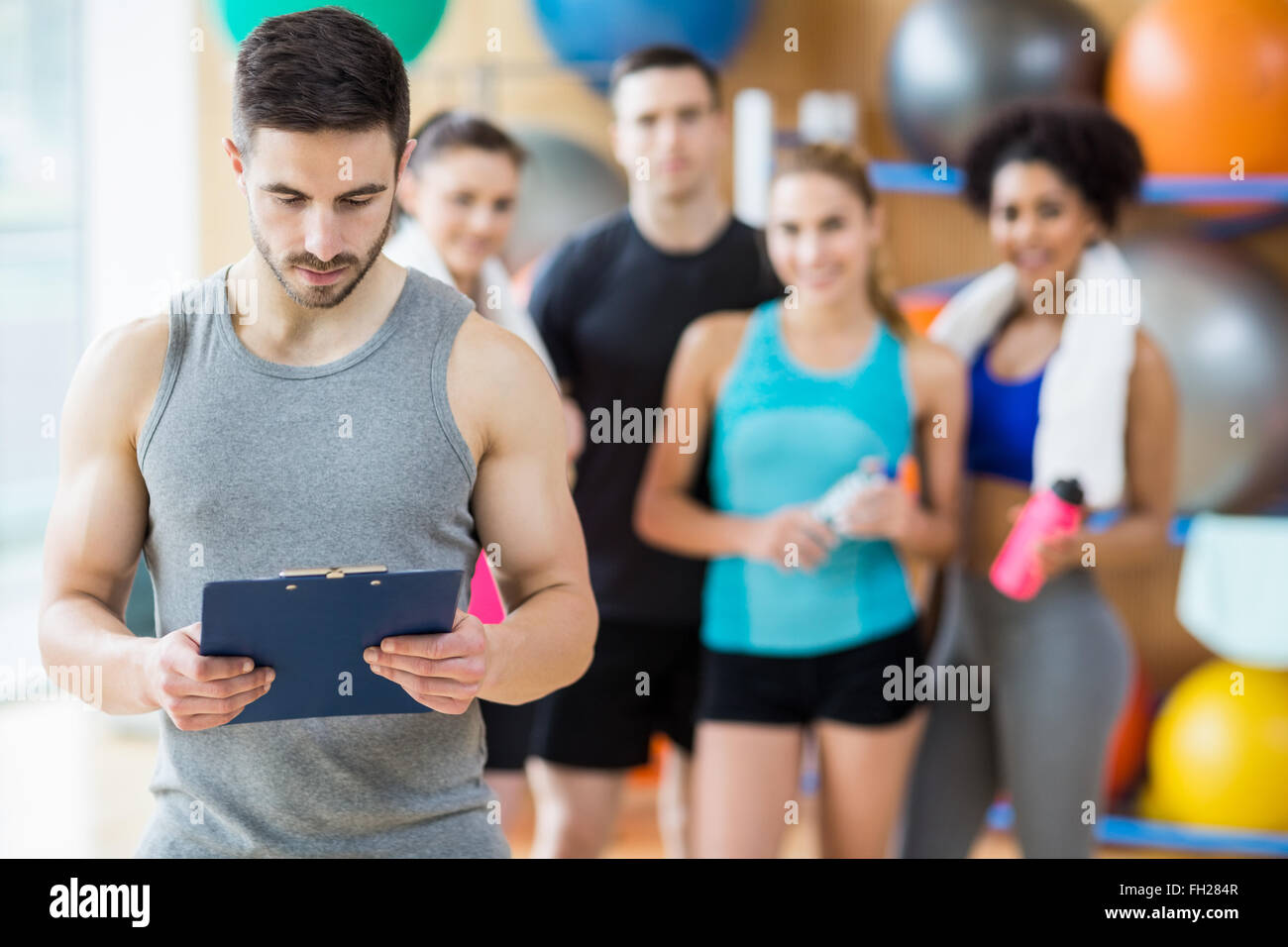 Fitness class smiling at camera in studio Stock Photo - Alamy