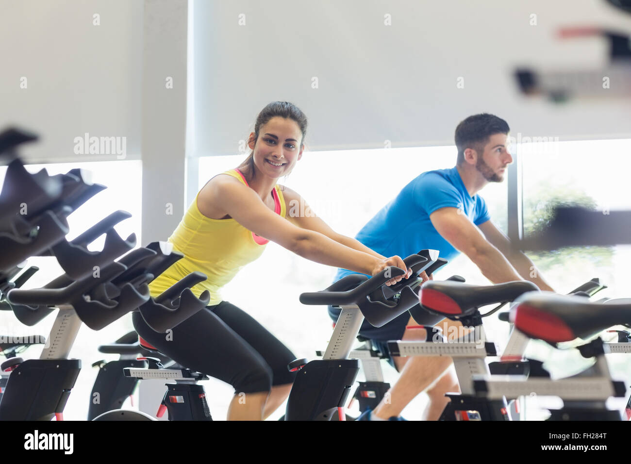 Couple using exercise bikes together Stock Photo - Alamy