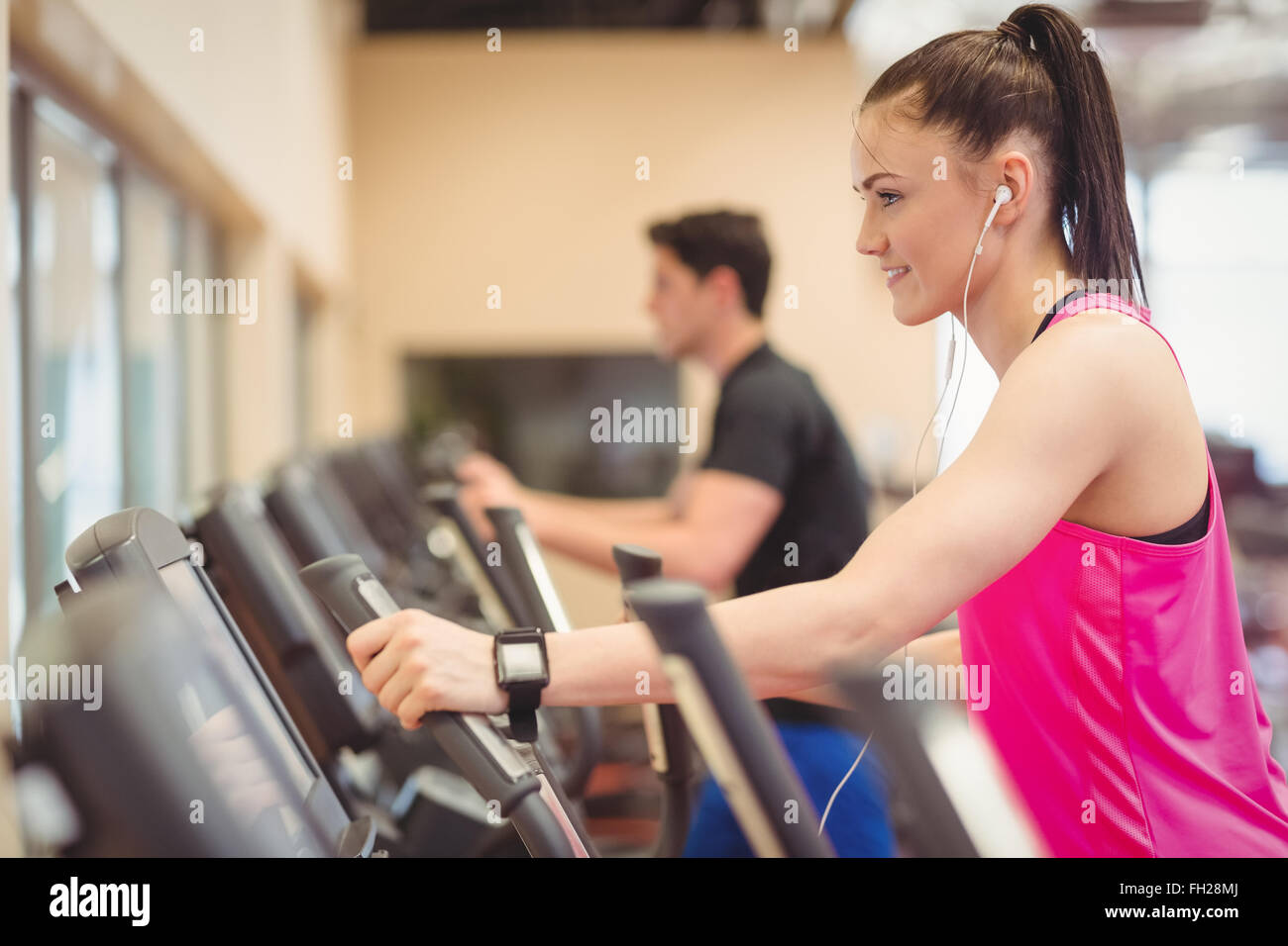 Fit people working out using machines Stock Photo - Alamy