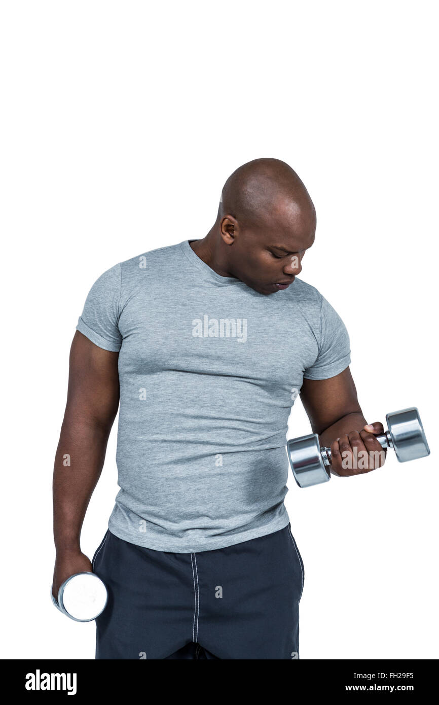 Fit man exercising with dumbbell Stock Photo - Alamy
