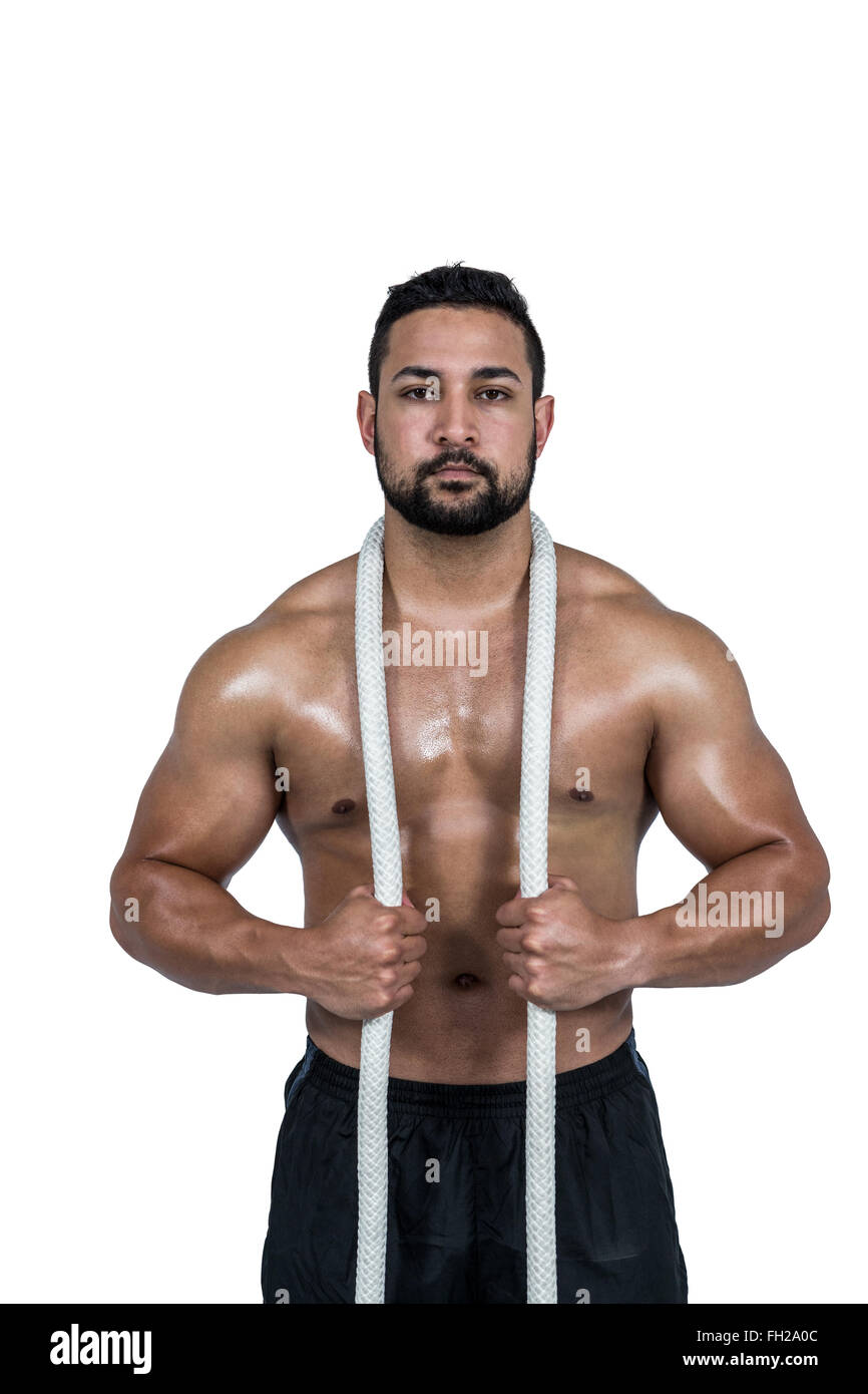 Muscular man with battle rope Stock Photo - Alamy