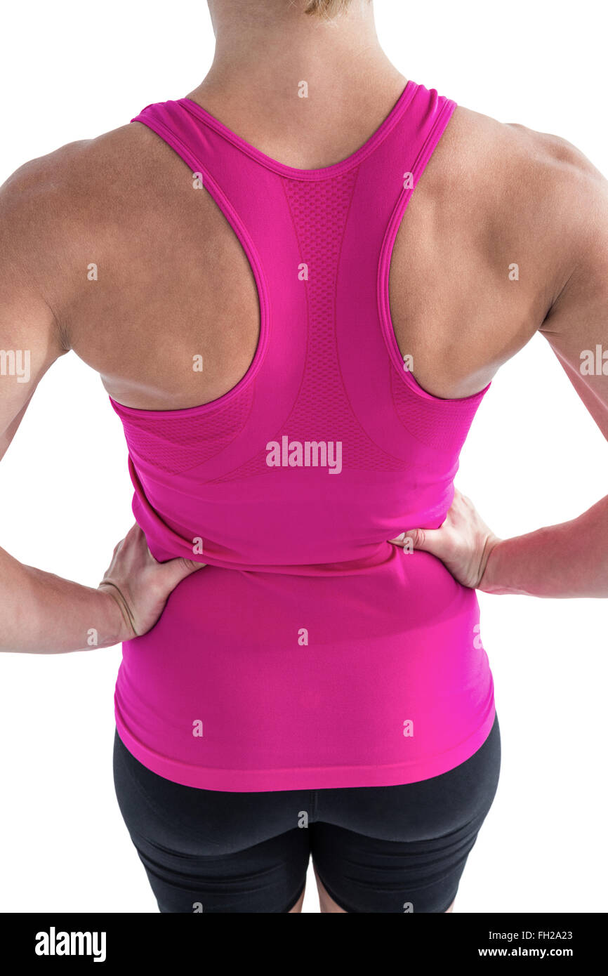 Rear view of muscular woman with hands hips Stock Photo - Alamy
