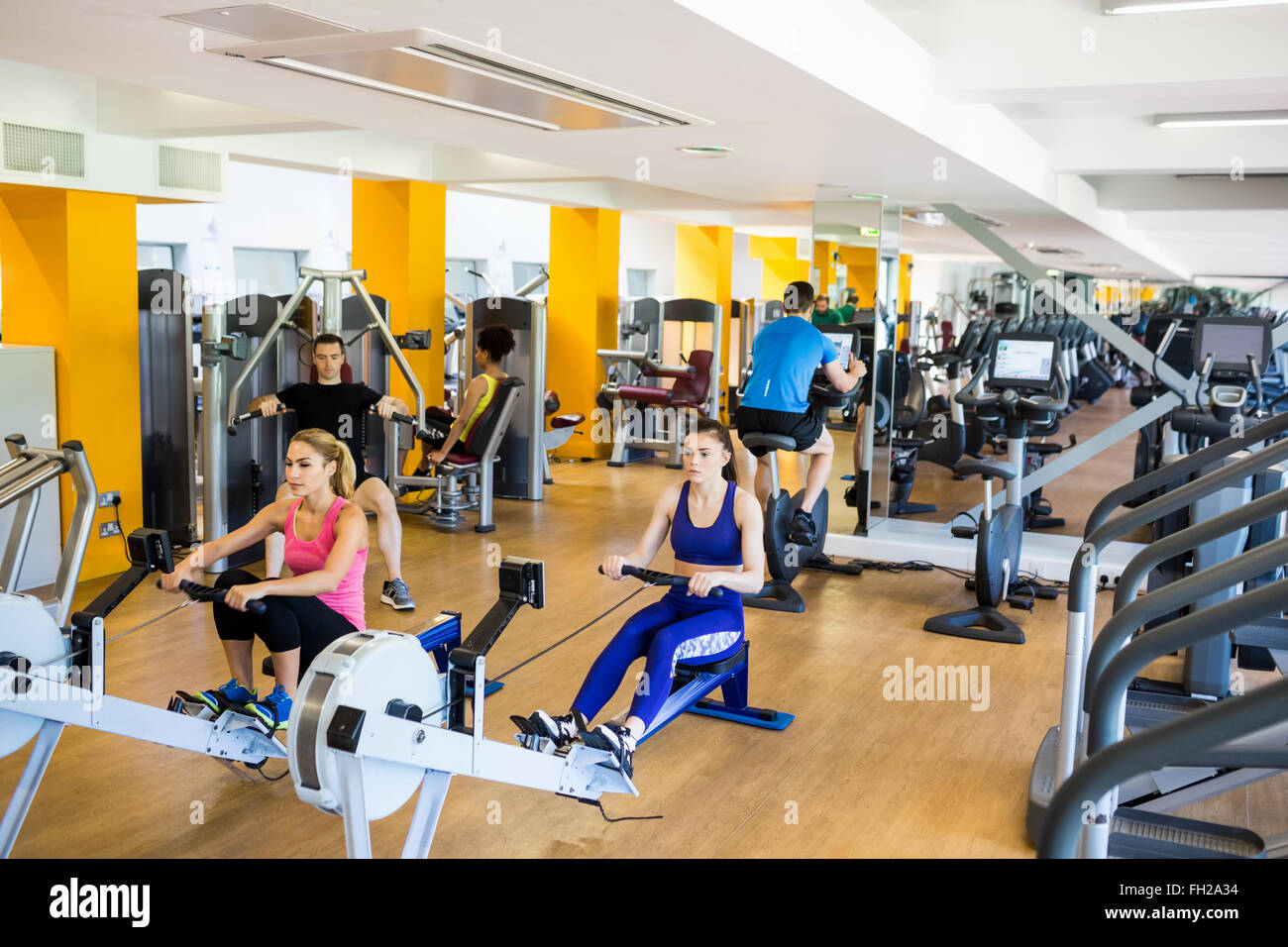 Fit people working out using machines Stock Photo - Alamy