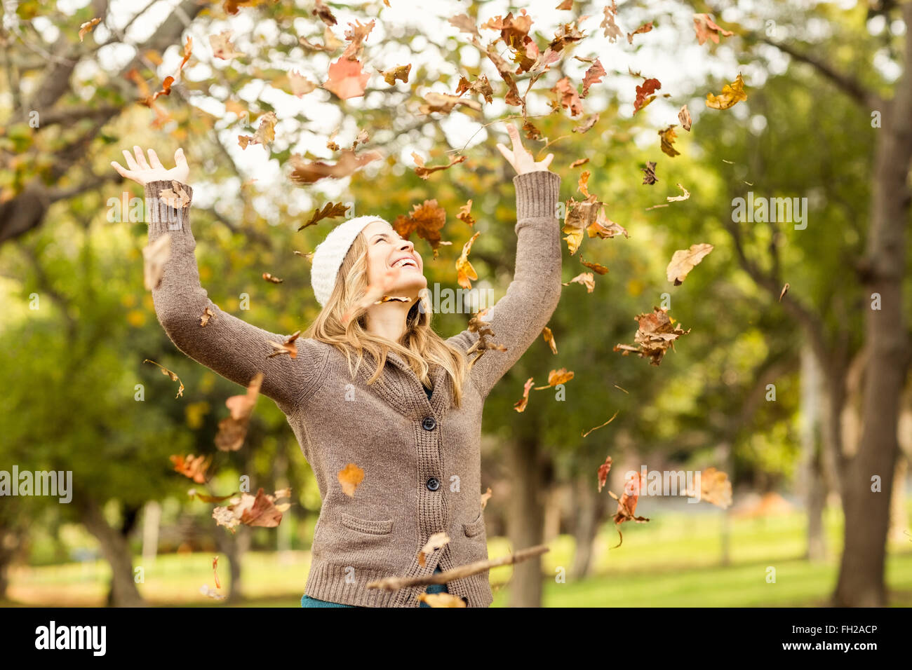 Beautiful young woman throwing leaves hi-res stock photography and ...