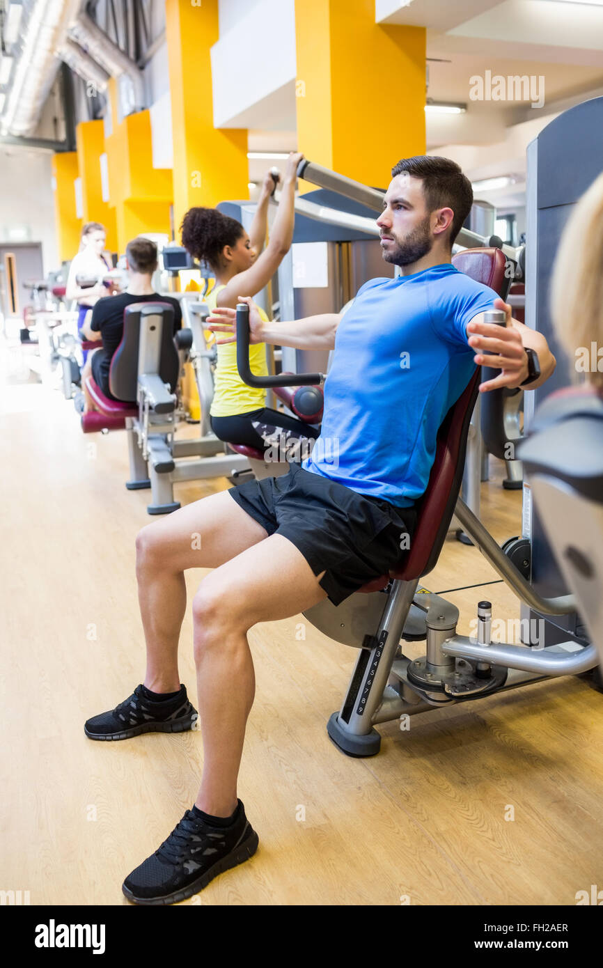 Fit people using weights machines Stock Photo - Alamy