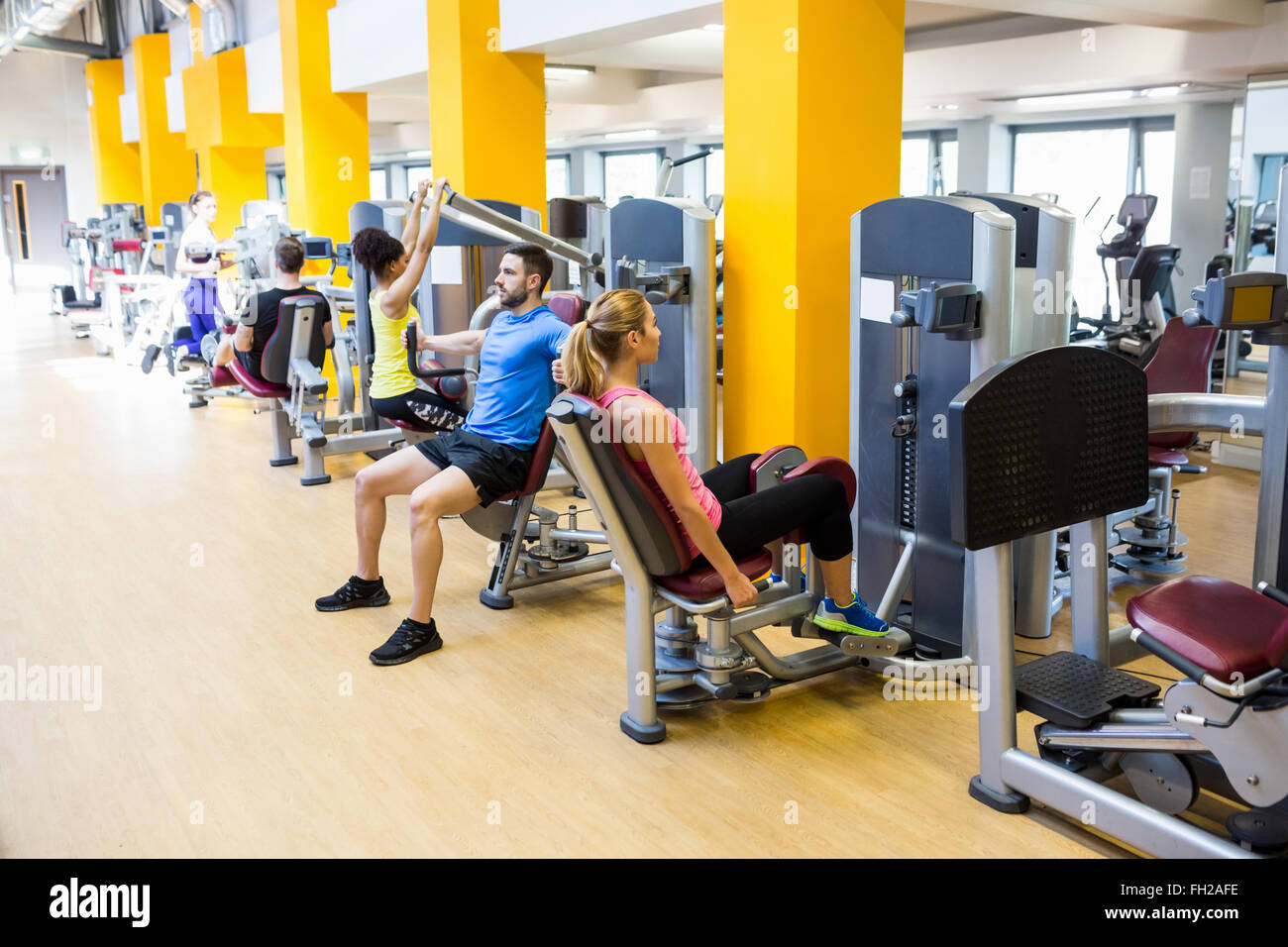 Fit people using weights machines Stock Photo - Alamy