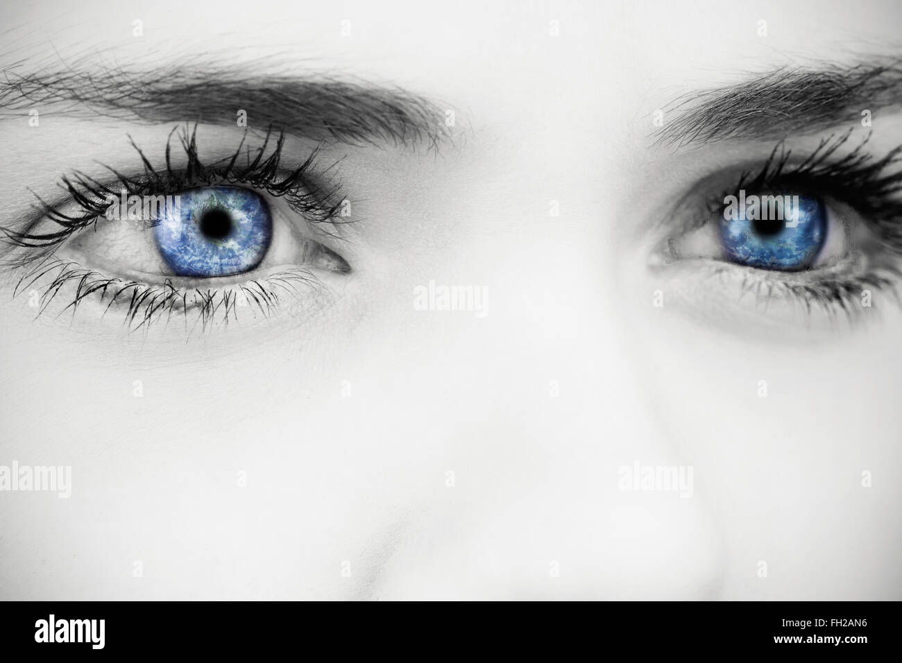 Composite image of blue eyes on grey face Stock Photo - Alamy